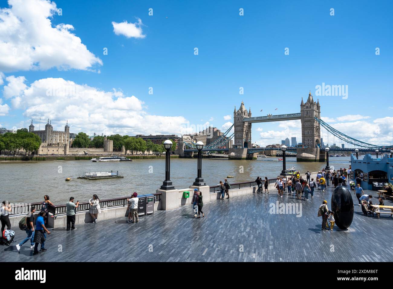 Tourists enjoying the iconic views of Tower Bridge and the Tower of ...