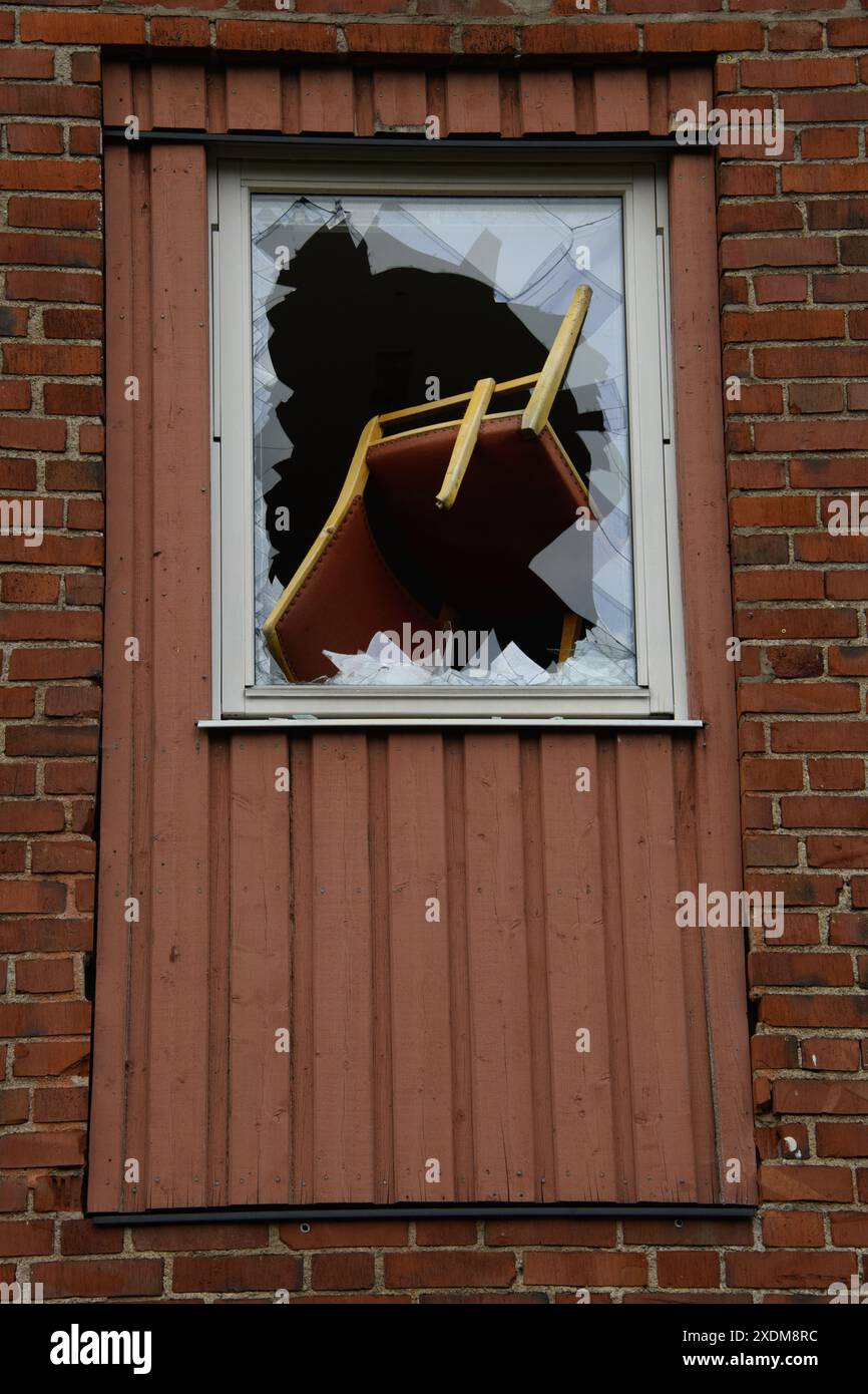Office Chair Embedded in Broken Window Stock Photo - Alamy
