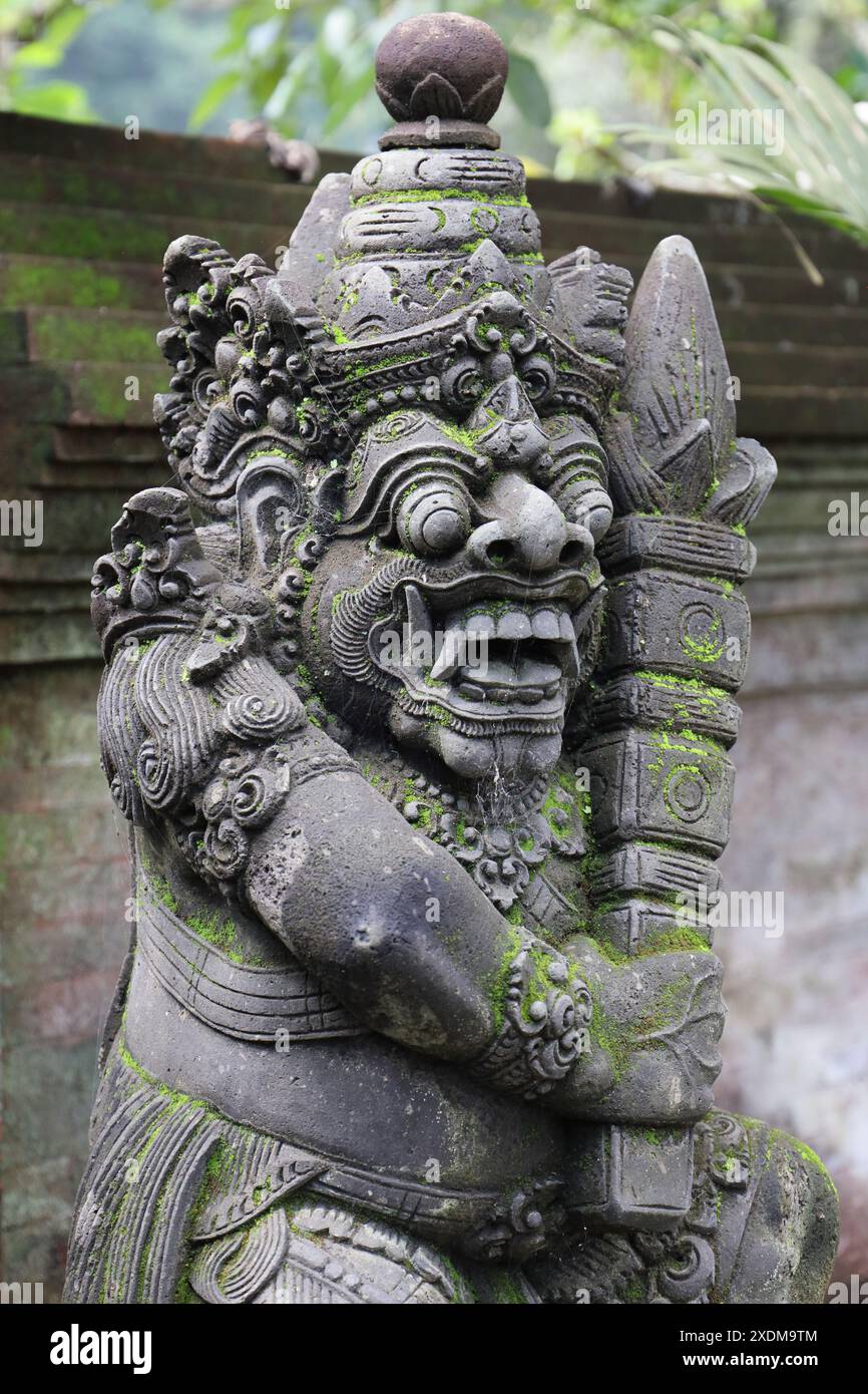 Stone statue of a Hindu god at Pura Tirta Empul, the Balinese Holy ...