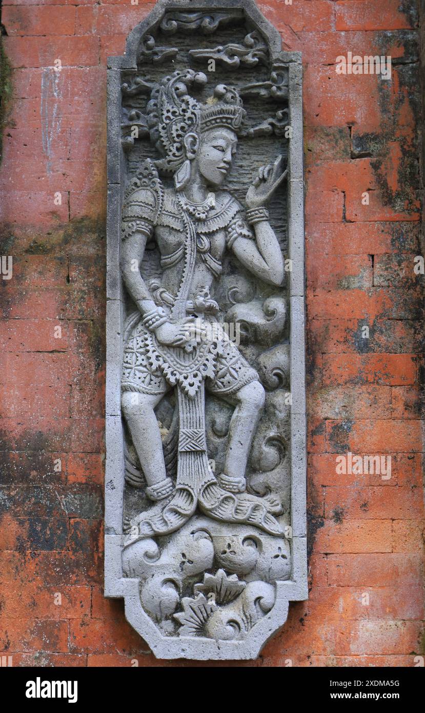 Stone basrelief of a Hindu god at Pura Tirta Empul, the Balinese Holy ...
