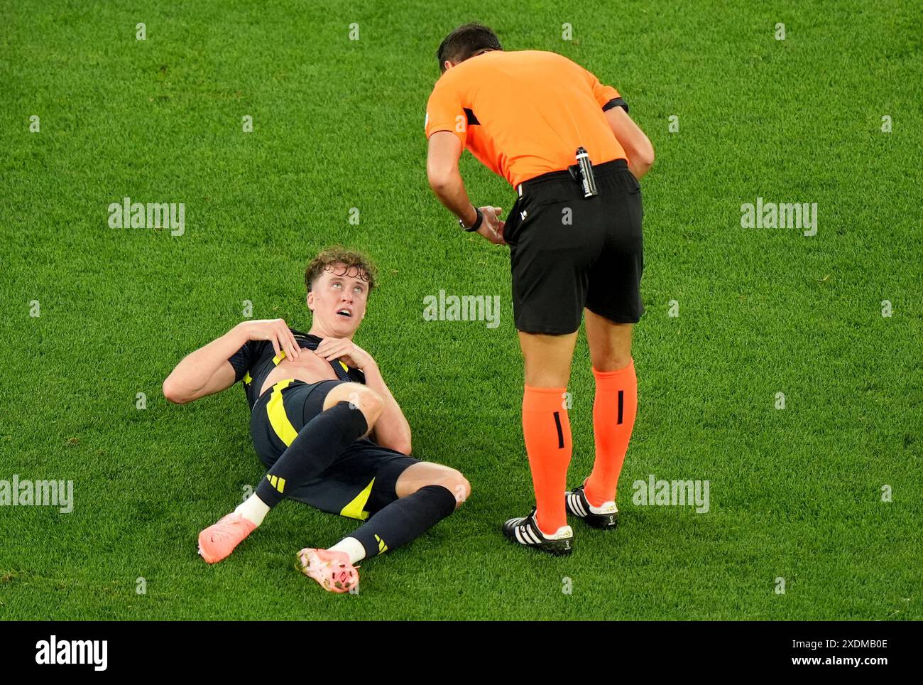 Scotland's Jack Hendry (left) shows referee Facundo Tello the marks on ...