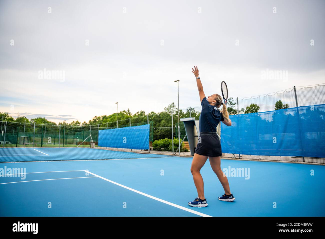 Professional female tennis player serving the tennis ball during ...