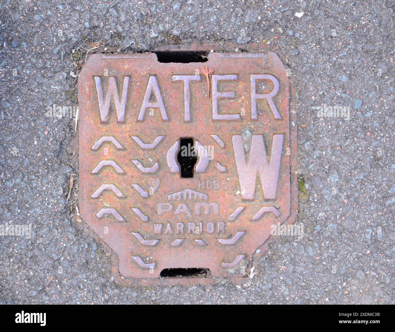 Sign on a water supply access cover in a pavement in Manchester, UK ...