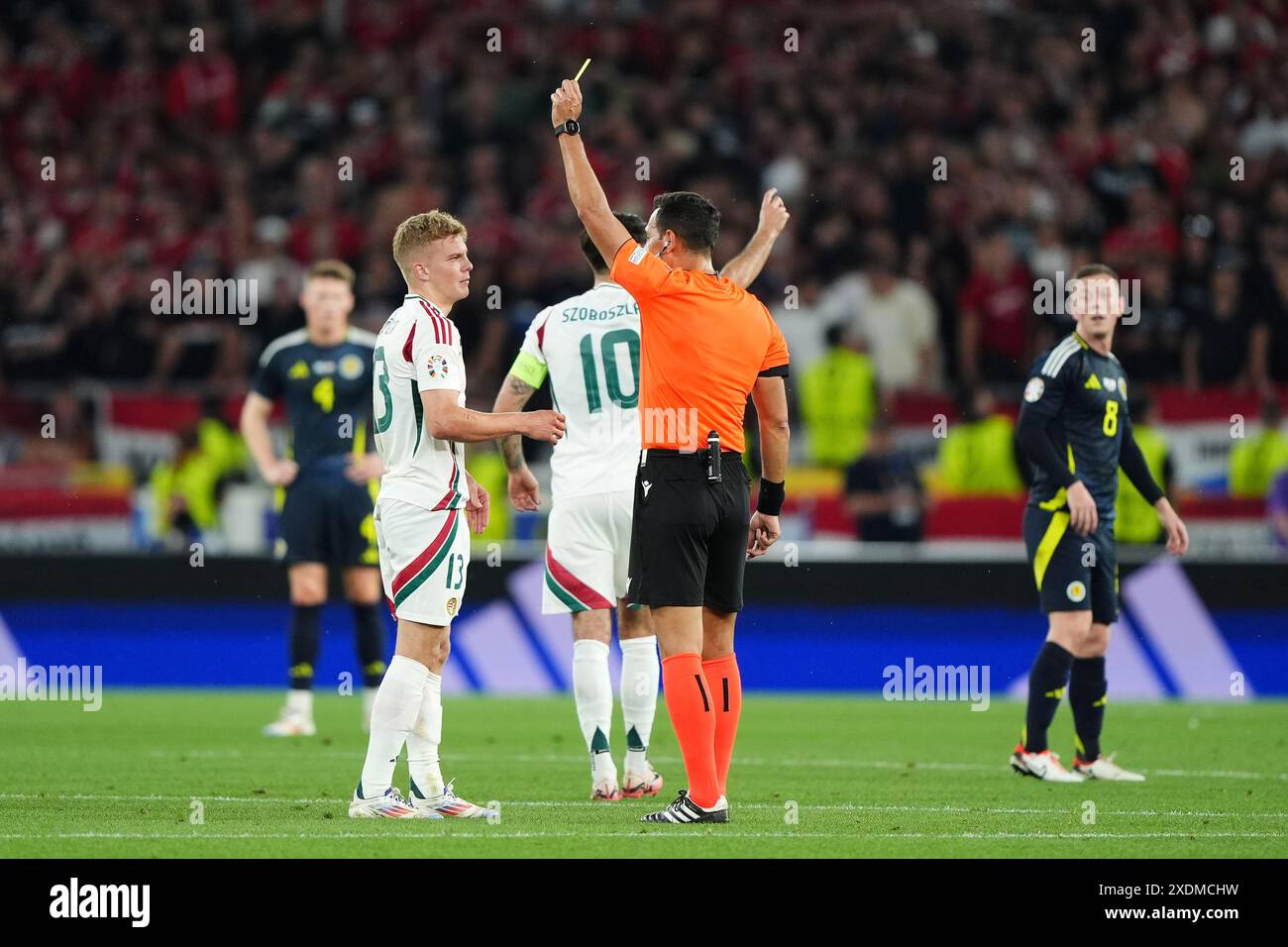 Hungary's Andras Schafer (left) is shown a yellow card by Referee ...