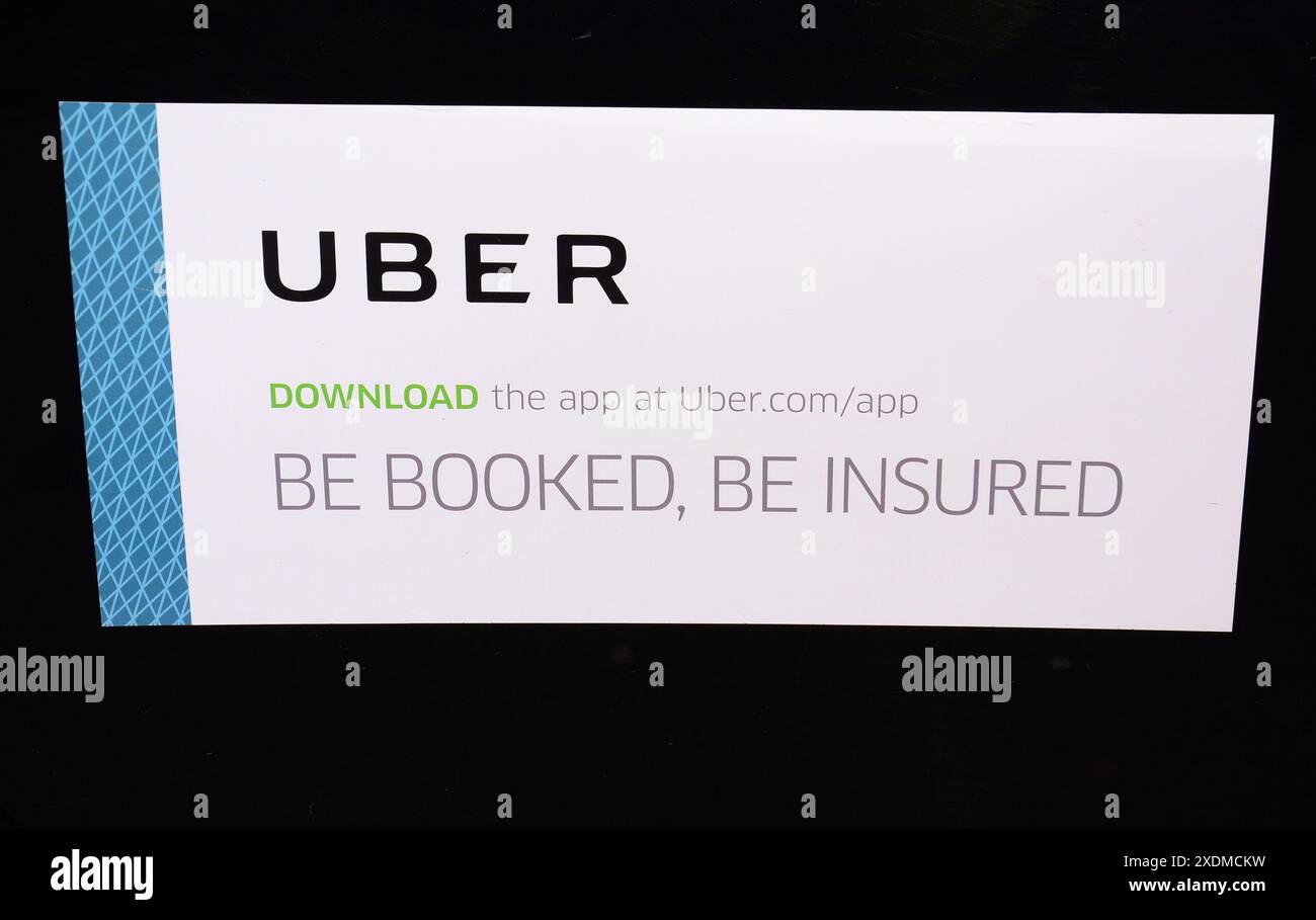 UBER notice on a car in Manchester, UK. UBER is an American ...