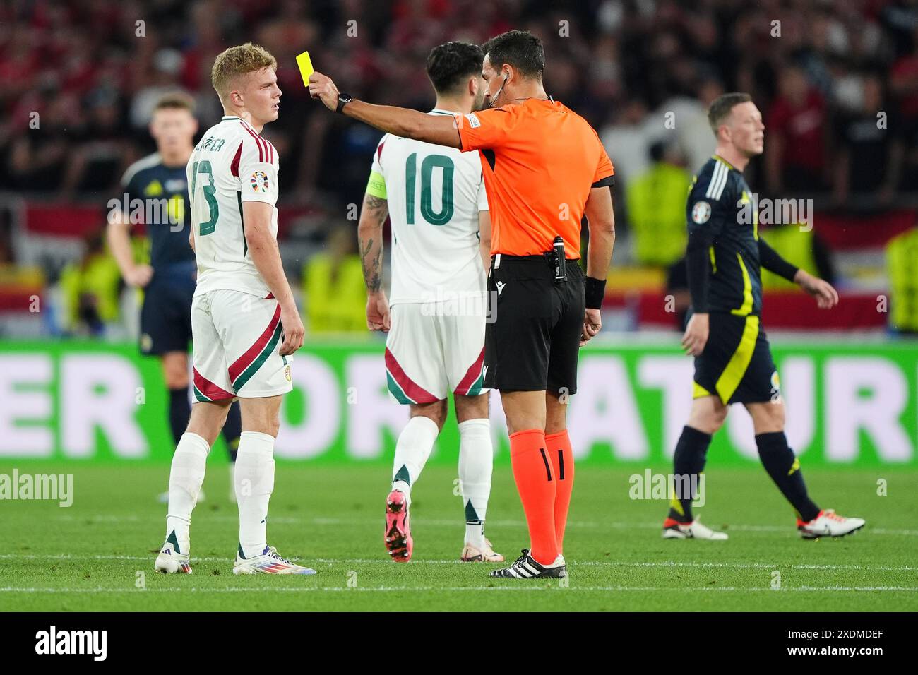 Hungary's Andras Schafer (left) is shown a yellow card by Referee ...