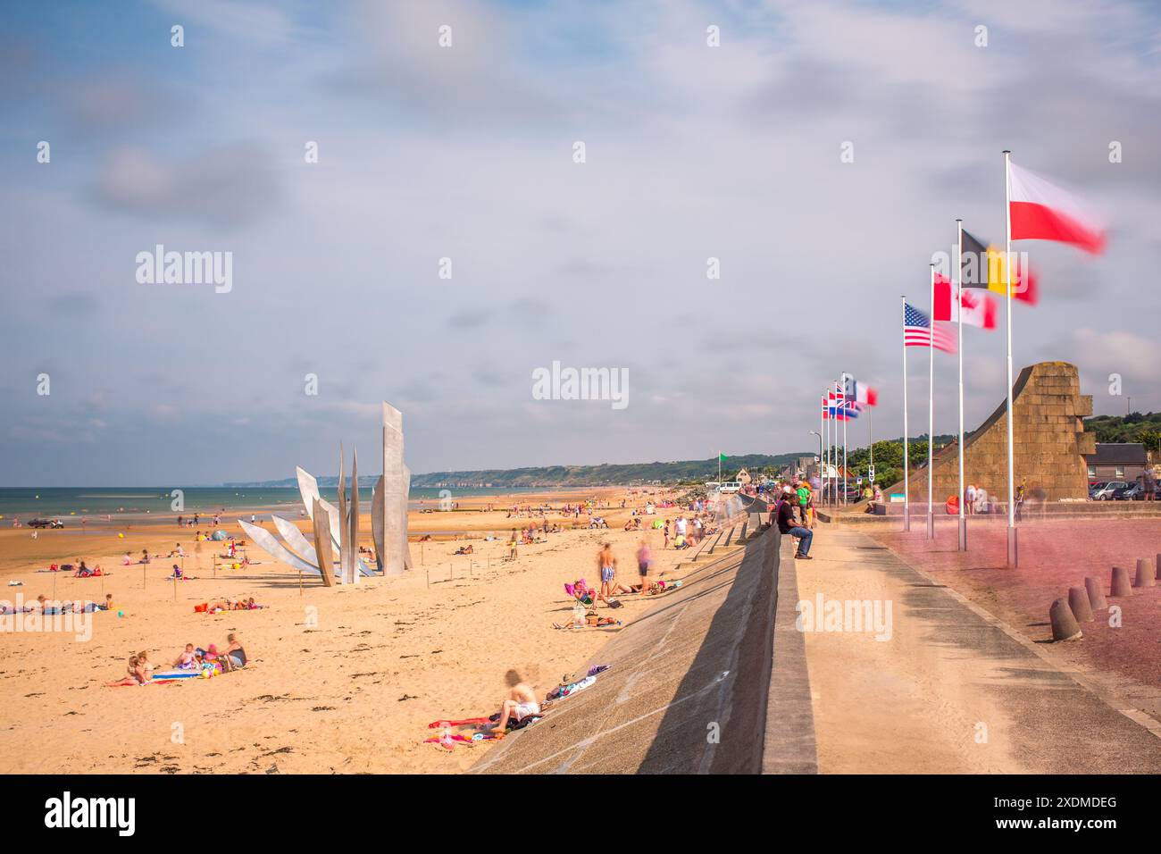 Long exposure image of Omaha Beach in Normandy, France with multiple national flags and ...