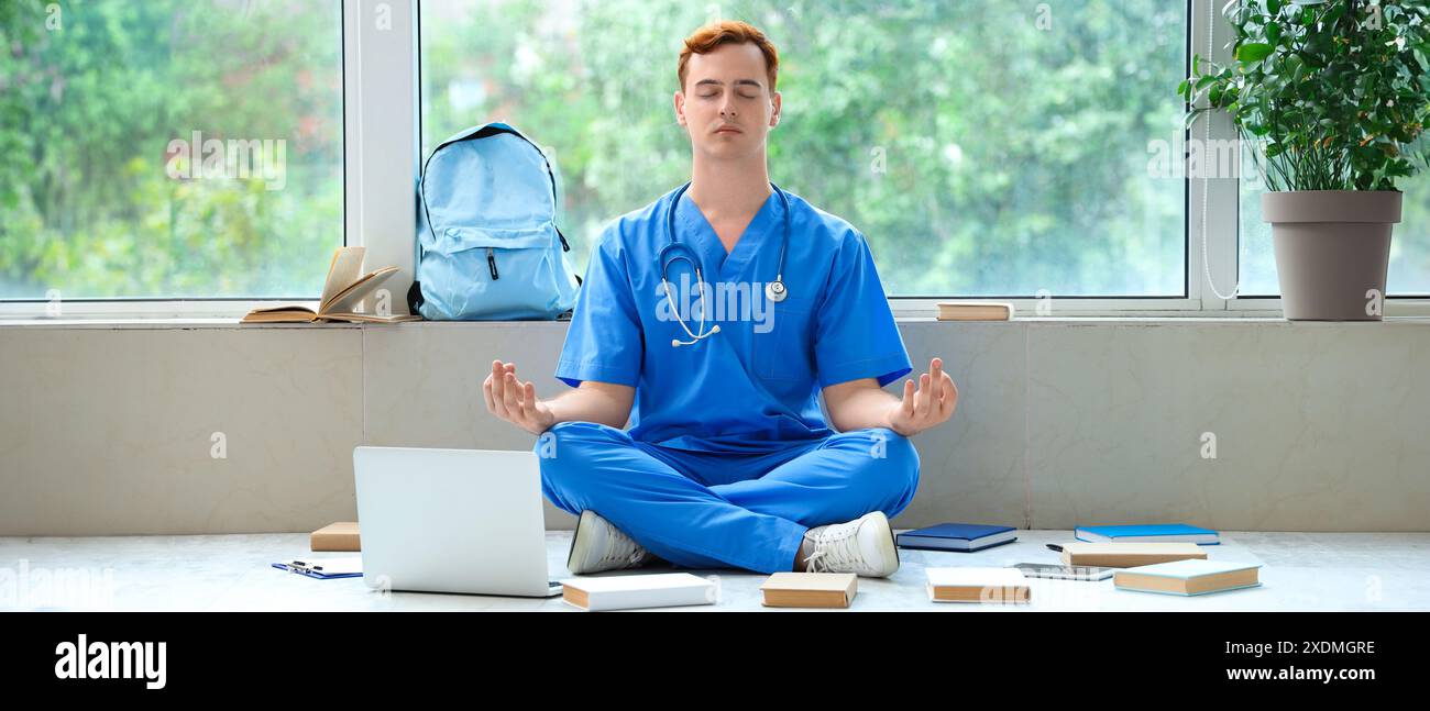 Male medical student meditating at university Stock Photo - Alamy