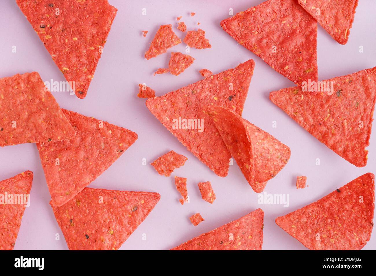 Red nachos on lilac background Stock Photo - Alamy