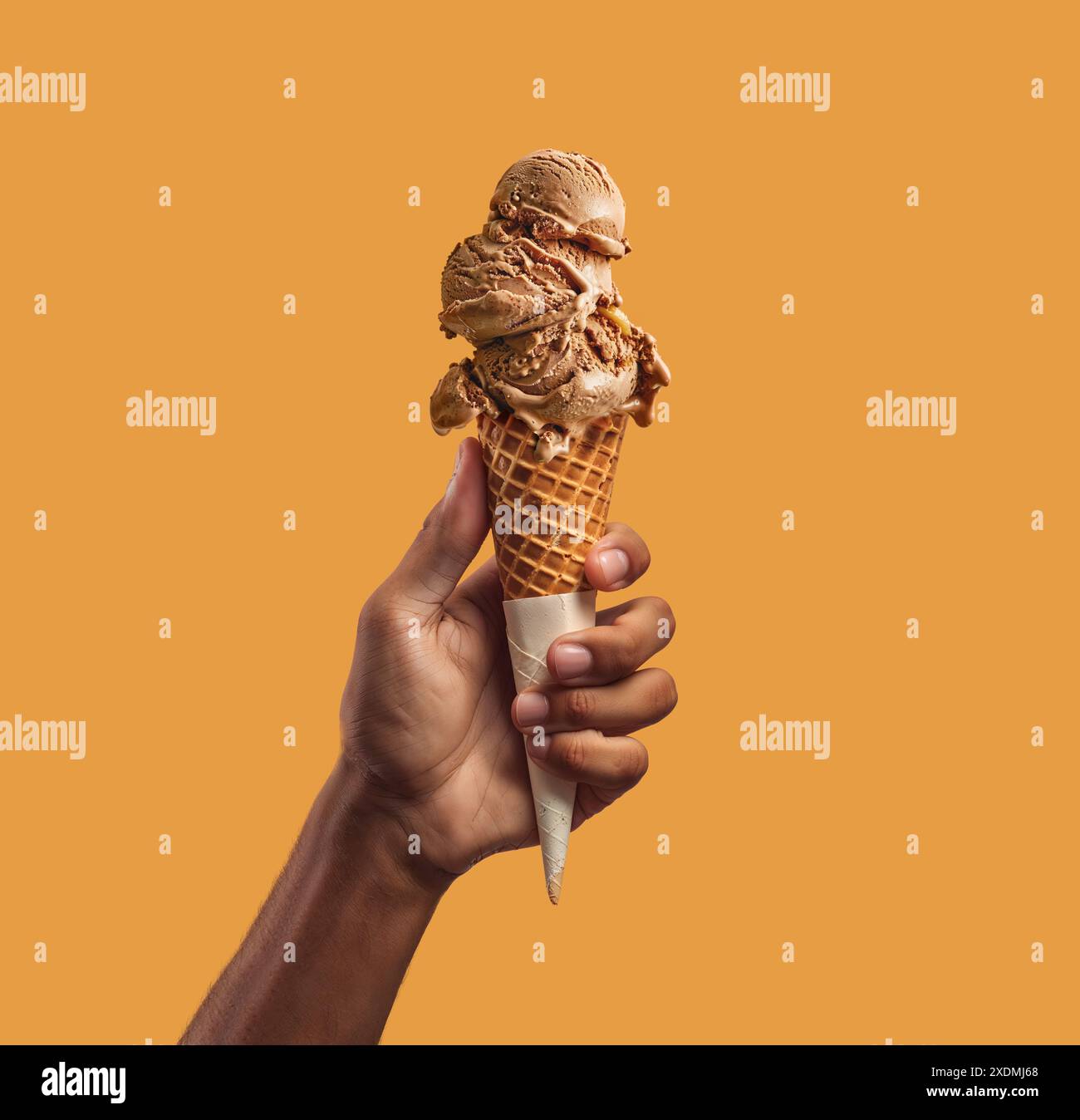 Delicious choco ice cream held by black man hand, orange background ...