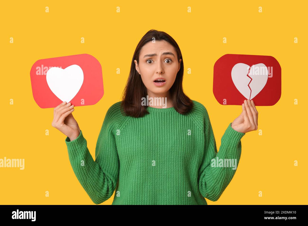 Beautiful young displeased woman with heart like and dislike icons on ...