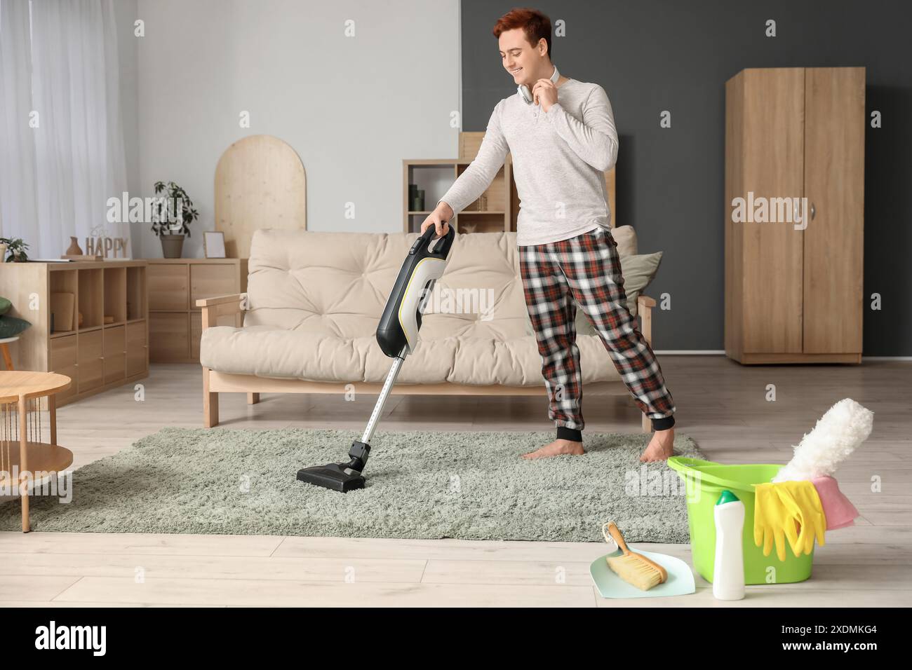 Man in headphones cleaning house hi-res stock photography and images ...