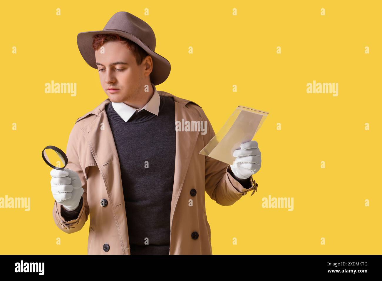 Male spy with magnifier and fingerprints on yellow background Stock ...