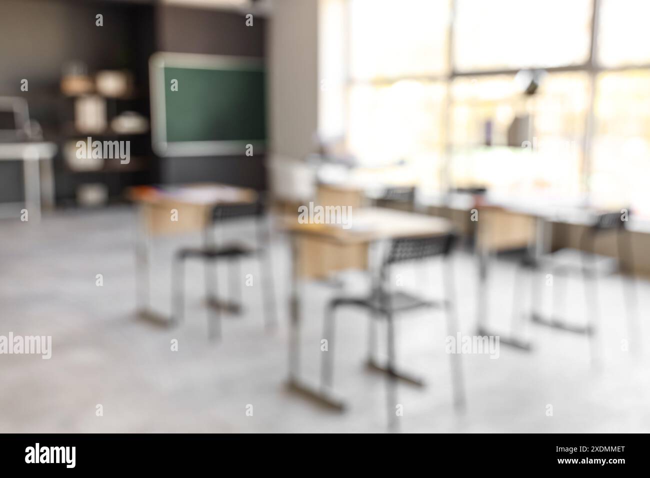 Blurred view of empty classroom with desks and chalkboard Stock Photo ...