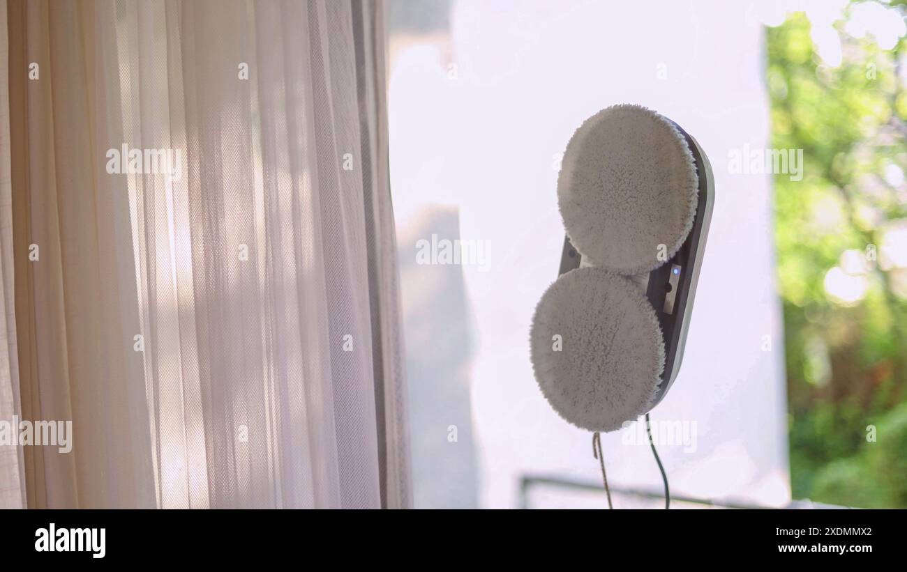 Window cleaning robot with visible rotating brushes on glass Stock ...