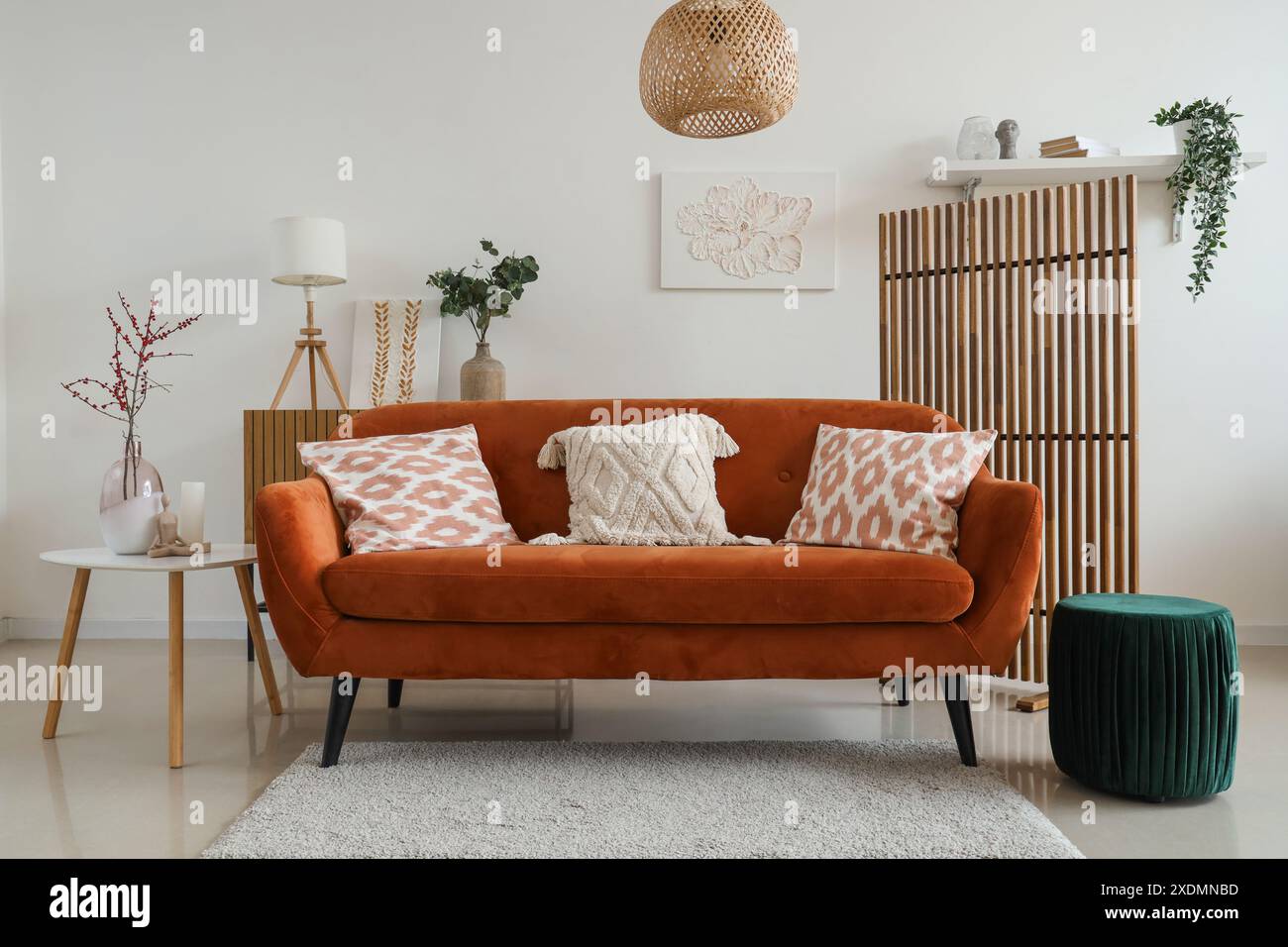 Interior of living room with red sofa, ottoman and folding screen Stock ...