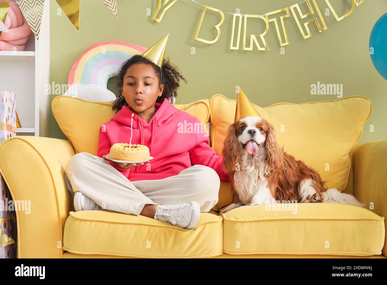 Teen African-American girl with cute cavalier King Charles spaniel and ...