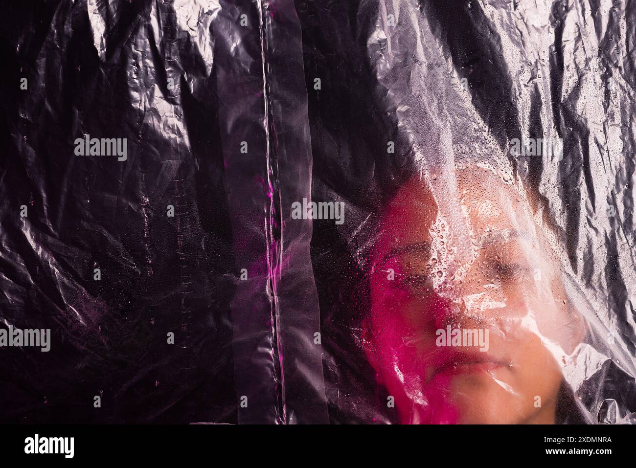 Beautiful woman behind transparent plastic feeling suffocated. Isolated ...