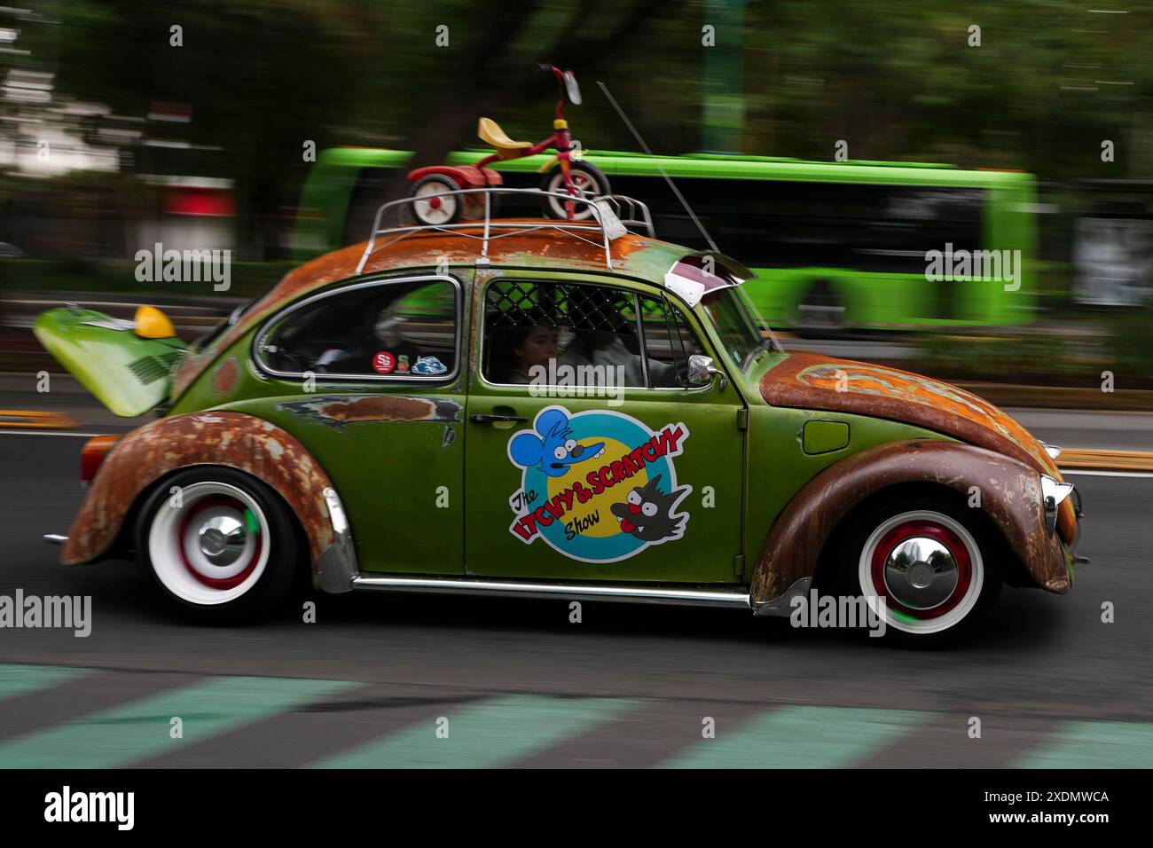 An antique Volkswagen Beetle, known in Mexico as a "vocho," parades ...