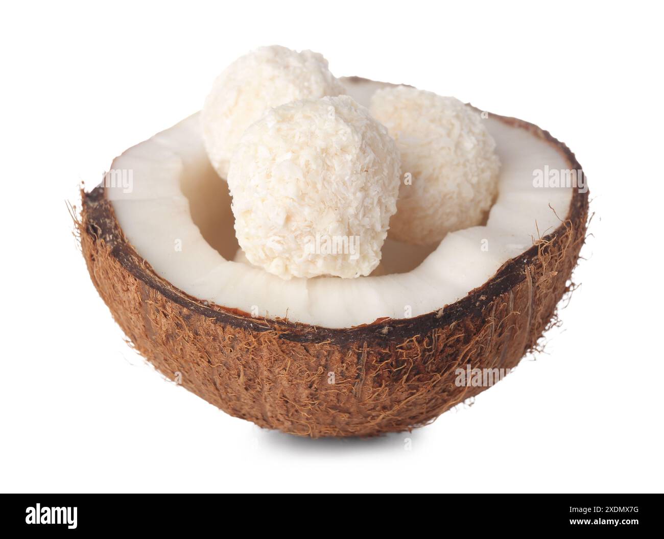 Coconut with delicious chocolate candies isolated on white background ...