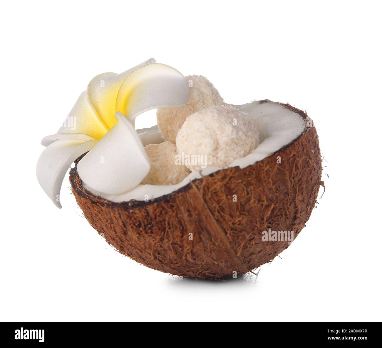 Coconut with delicious chocolate candies and plumeria flower isolated ...