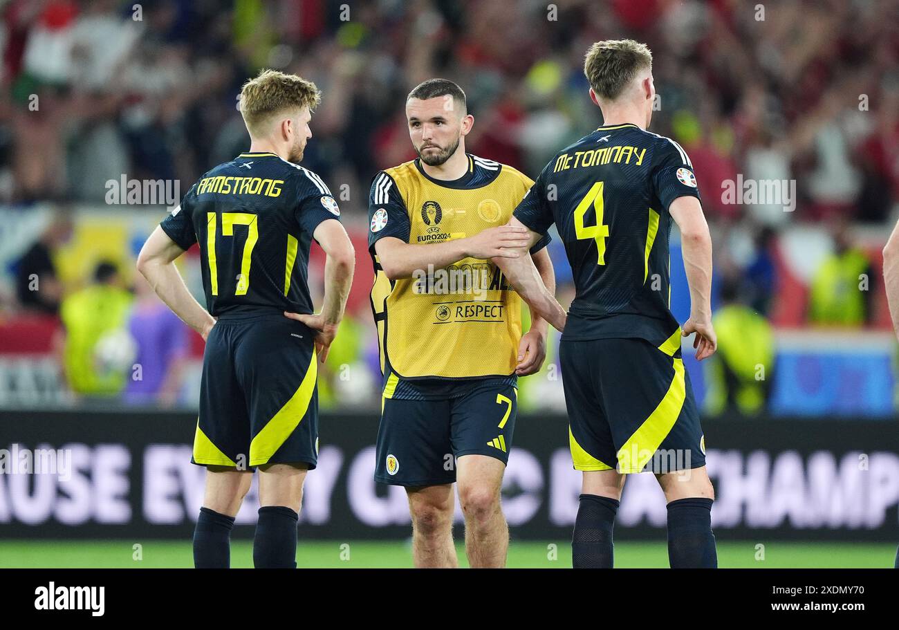 Scotland's John McGinn (centre) consoles Stuart Armstrong (left) and ...