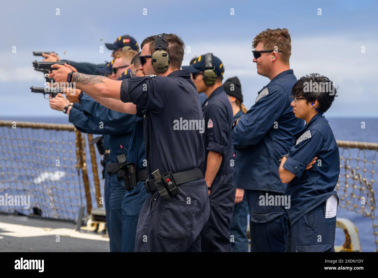 Sailors shoot the M9 service pistol during a live fire exercise on the ...