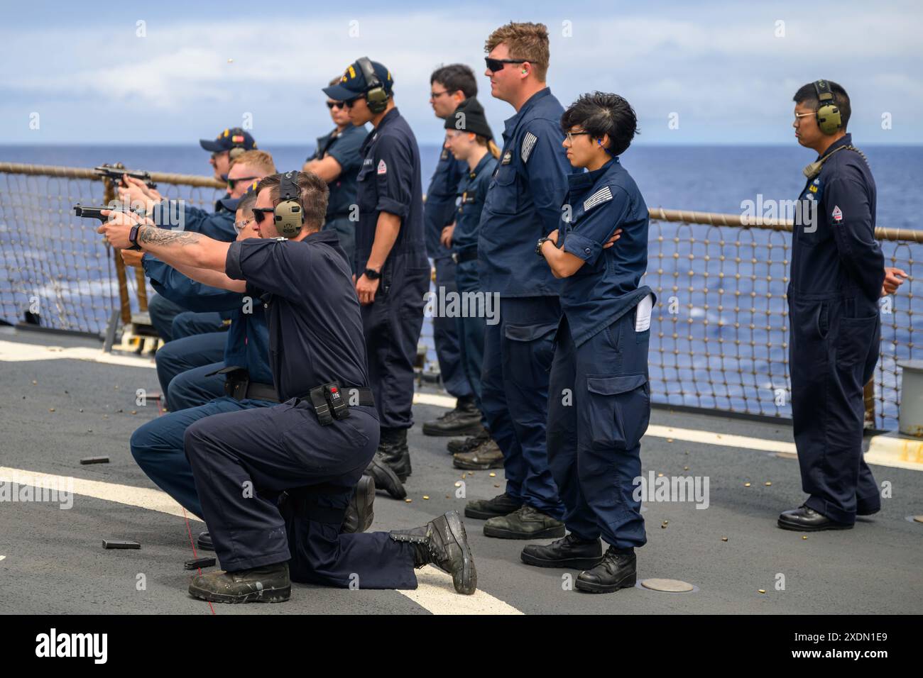 Sailors shoot the M9 service pistol during a live fire exercise on the ...