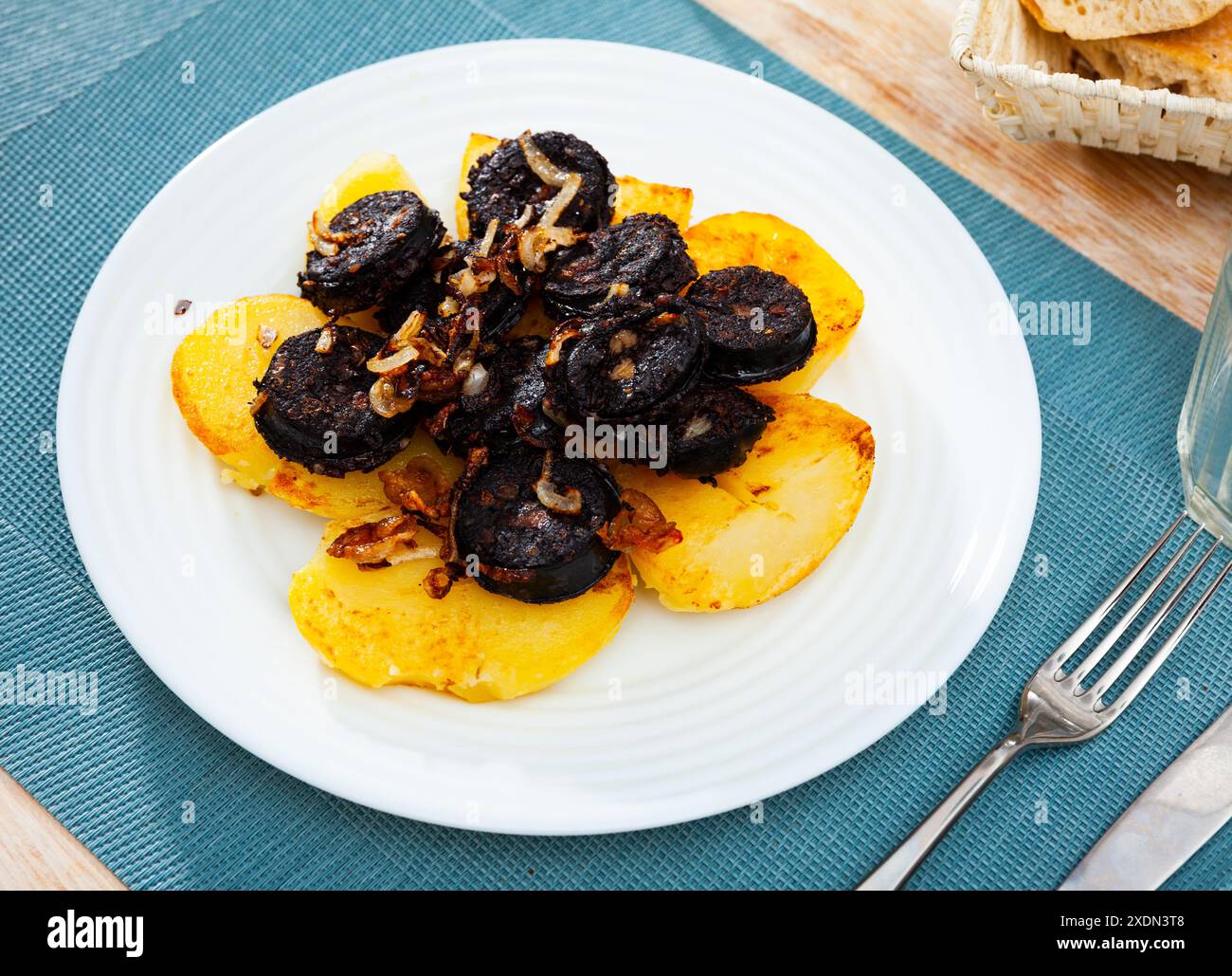 Fried blood sausage with potatoes served at plate Stock Photo - Alamy