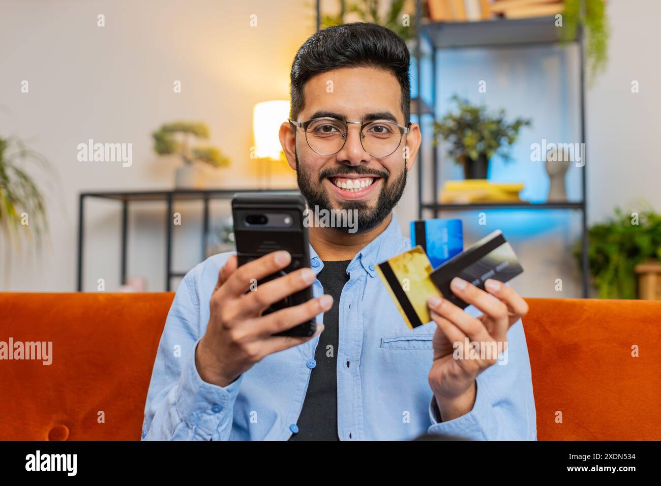 Happy young Indian man doing payments online purchase shopping in ...