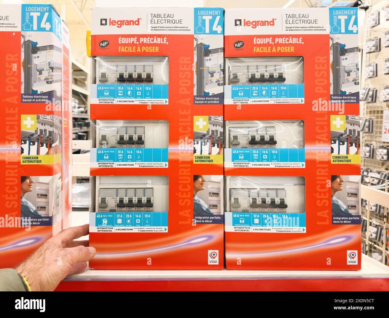 Paris, France - Apr 24, 2024:A hand selecting a Legrand electrical ...