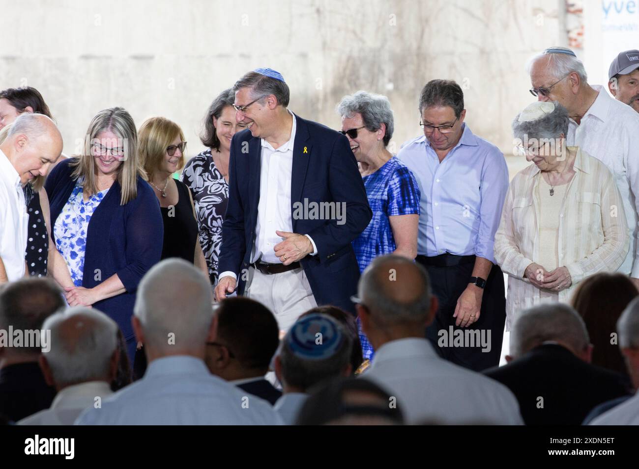 Survivors, family members and other dignitaries participate in breaking ...