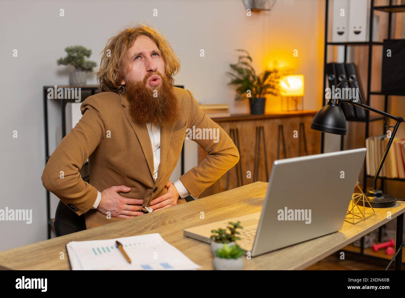 Disappointed Caucasian freelancer feeling overeating during work ...