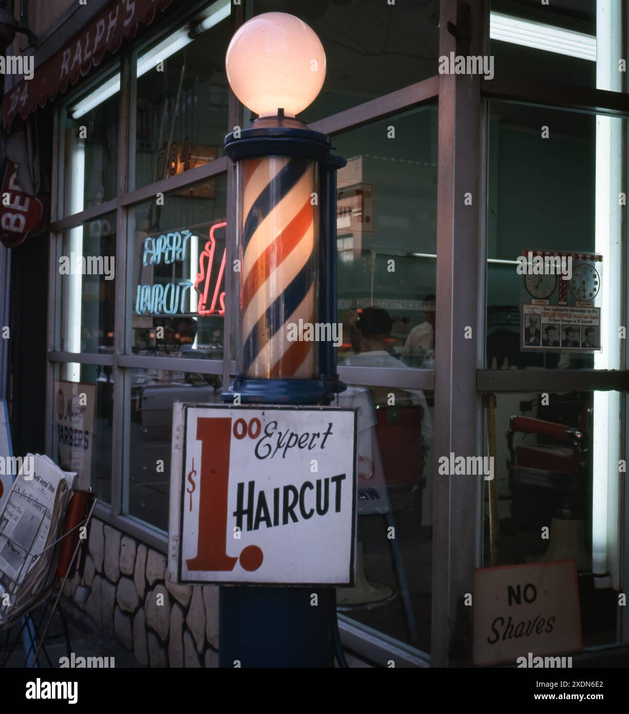 Retro photo barber shop pole. $1 expert haircut Stock Photo - Alamy
