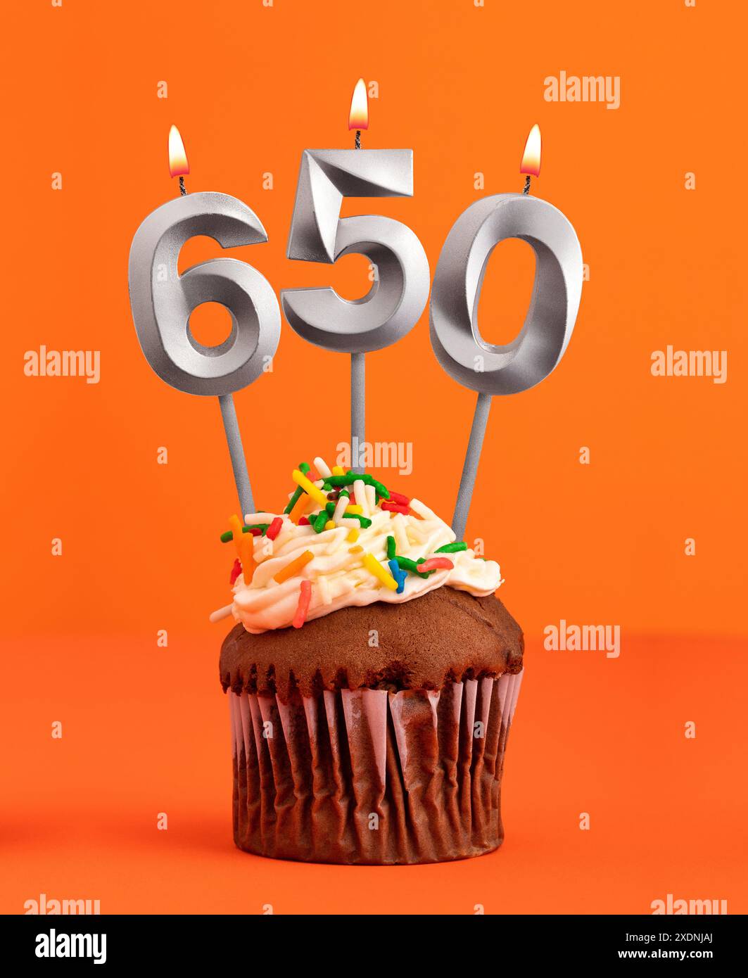 Birthday cupcake with number 650 candle - Orange color background Stock ...
