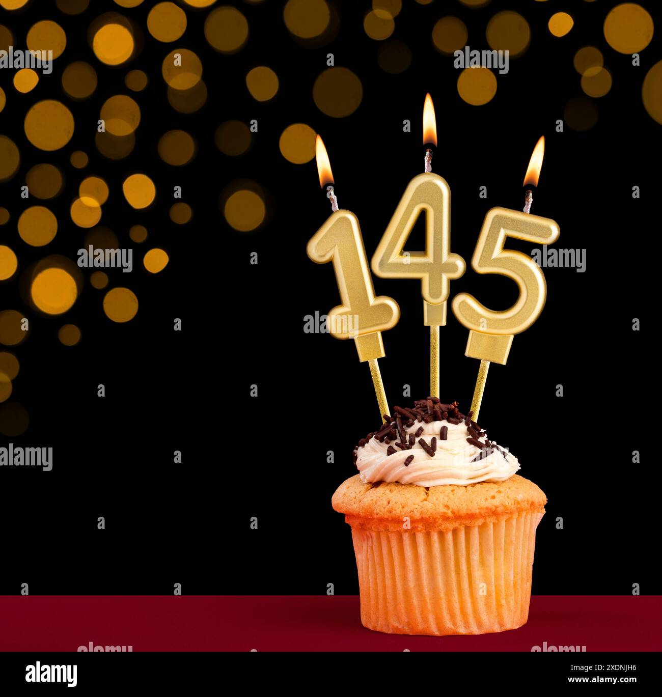 Number 145 birthday candle - Cupcake on black background with out of ...