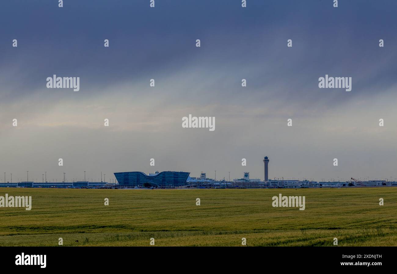 Denver International Airport in the distance against the stormy sky ...