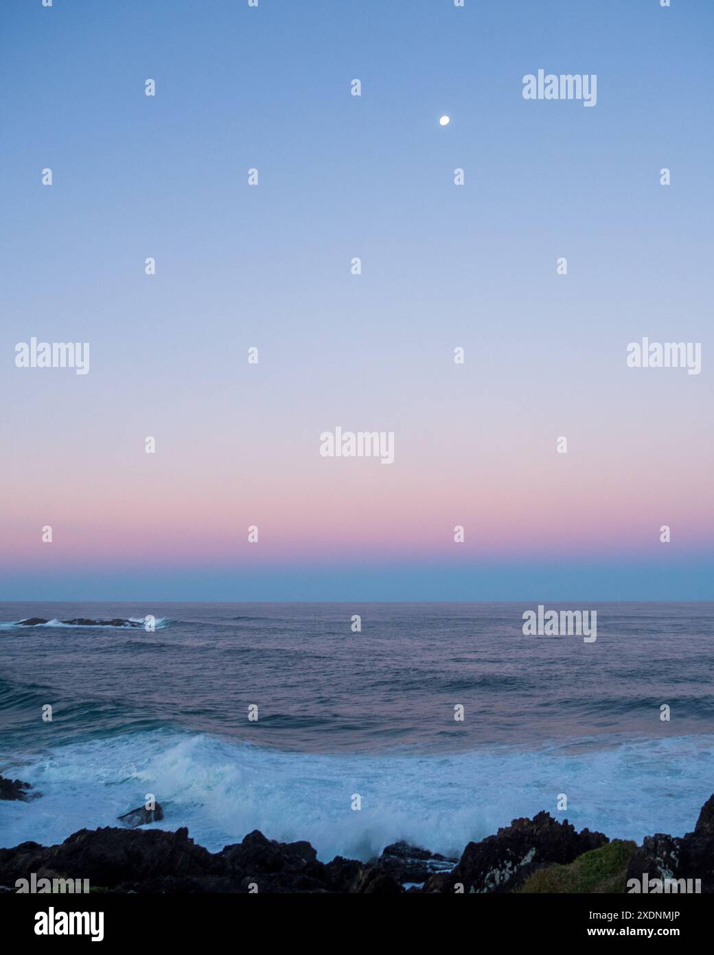 Gorgeous pink pale orange and blue sunset reflected in clouds to the ...