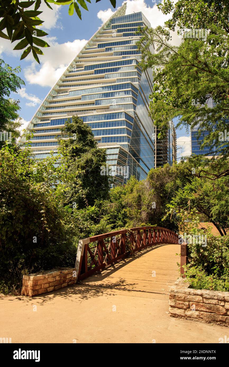 In downtown Austin, Texas, a modern glass skyscraper stands tall behind ...