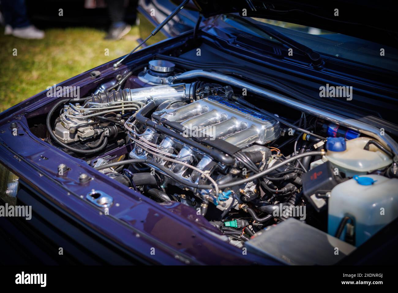 the engine compartment of a VW Golf contains a tuned engine Stock Photo ...
