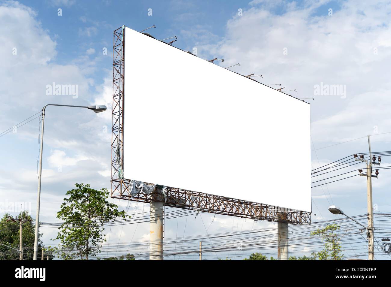 Blank billboard on blue sky background for new advertisement in a city ...