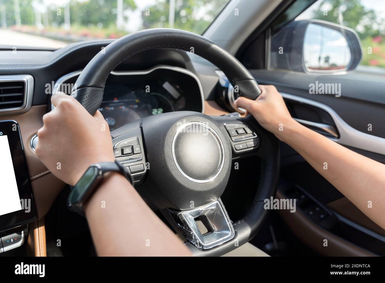 Female hand holding steering wheel in a car during a drive. Caucasian ...