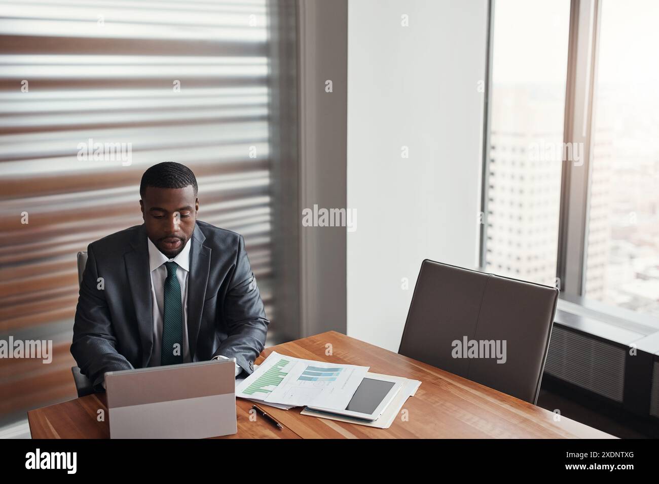 Black man, banker and laptop in office for finance, research and ...