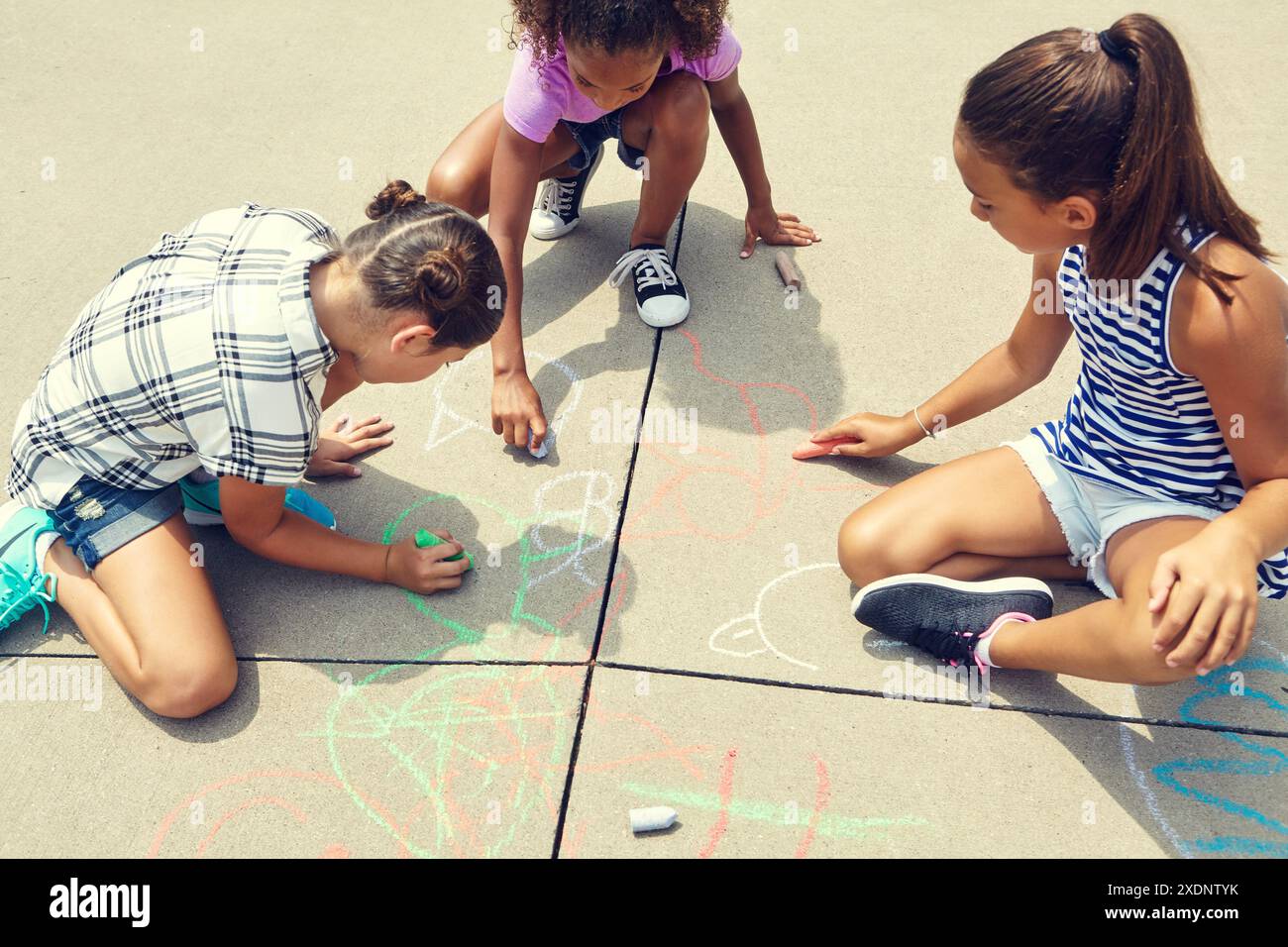 Girl, children and friends on ground with chalk on concrete for ...
