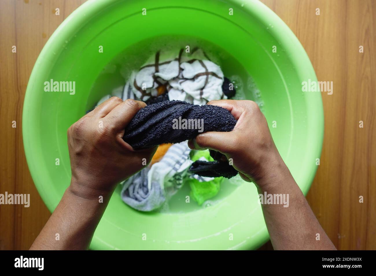 Person washes clothes in green hi-res stock photography and images - Alamy