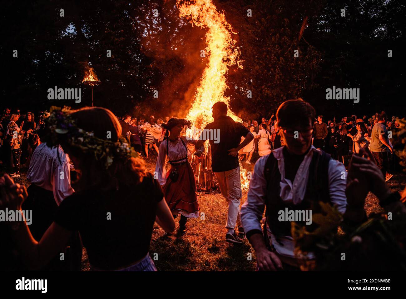 People dance around bonfire as they celebrate the Saint John's Day and ...