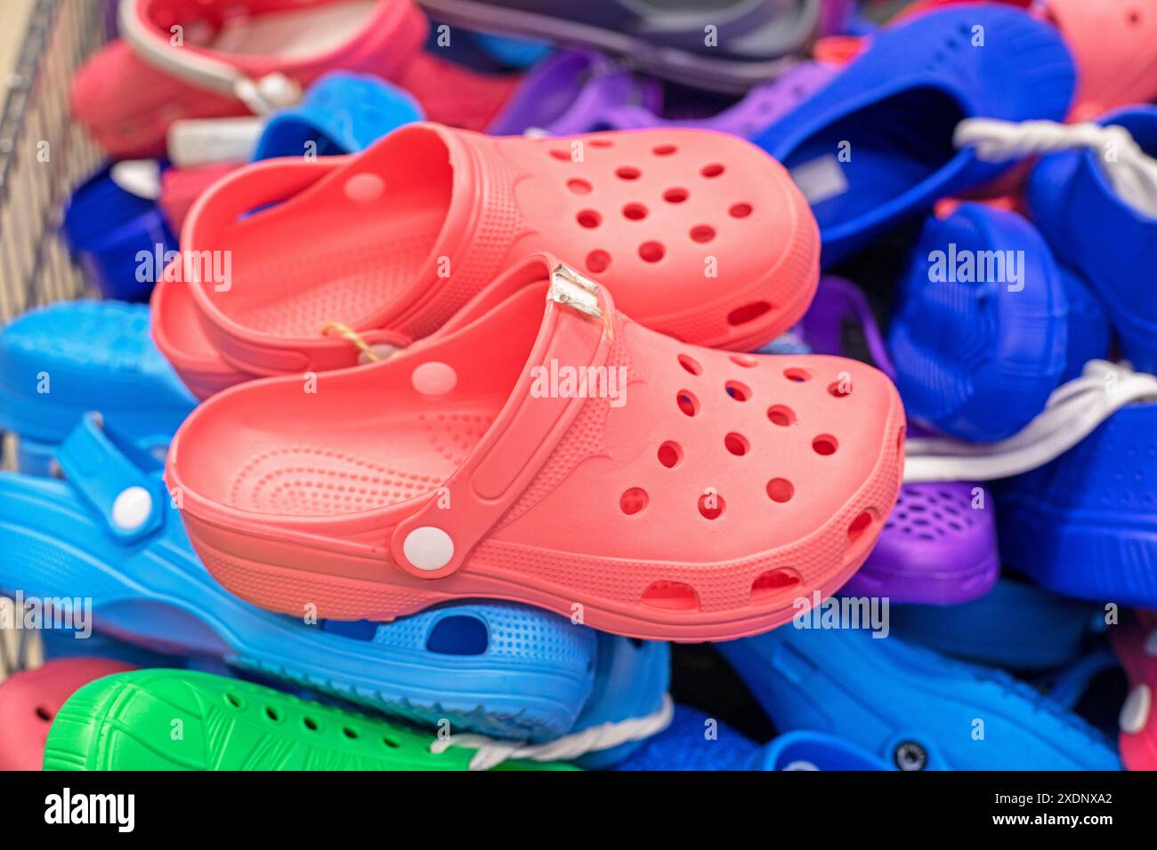 pink rubber summer slippers crocsi in the store in a container with ...