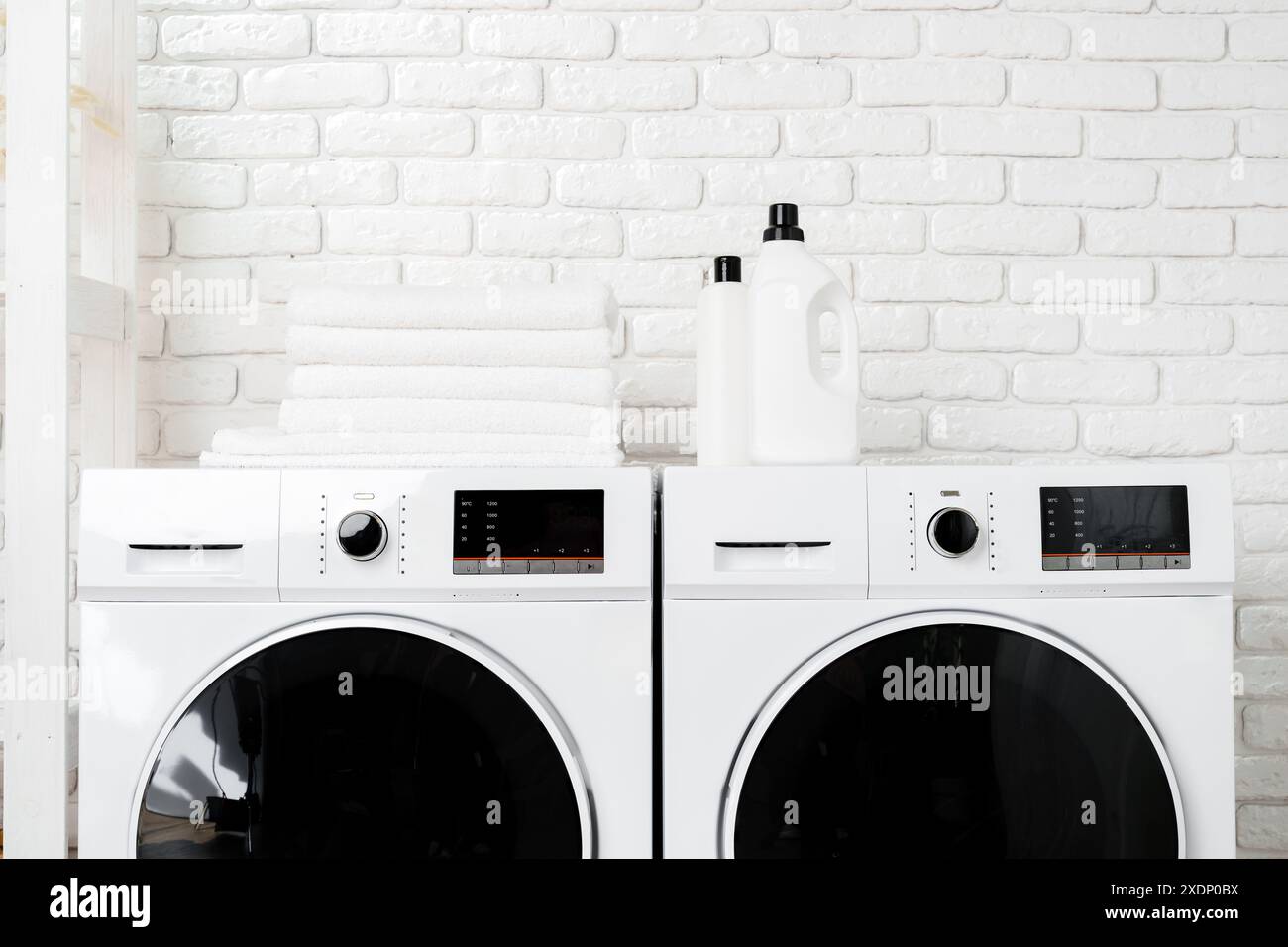 Two White Front Loading Washing Machines in Modern Laundry Room Stock ...