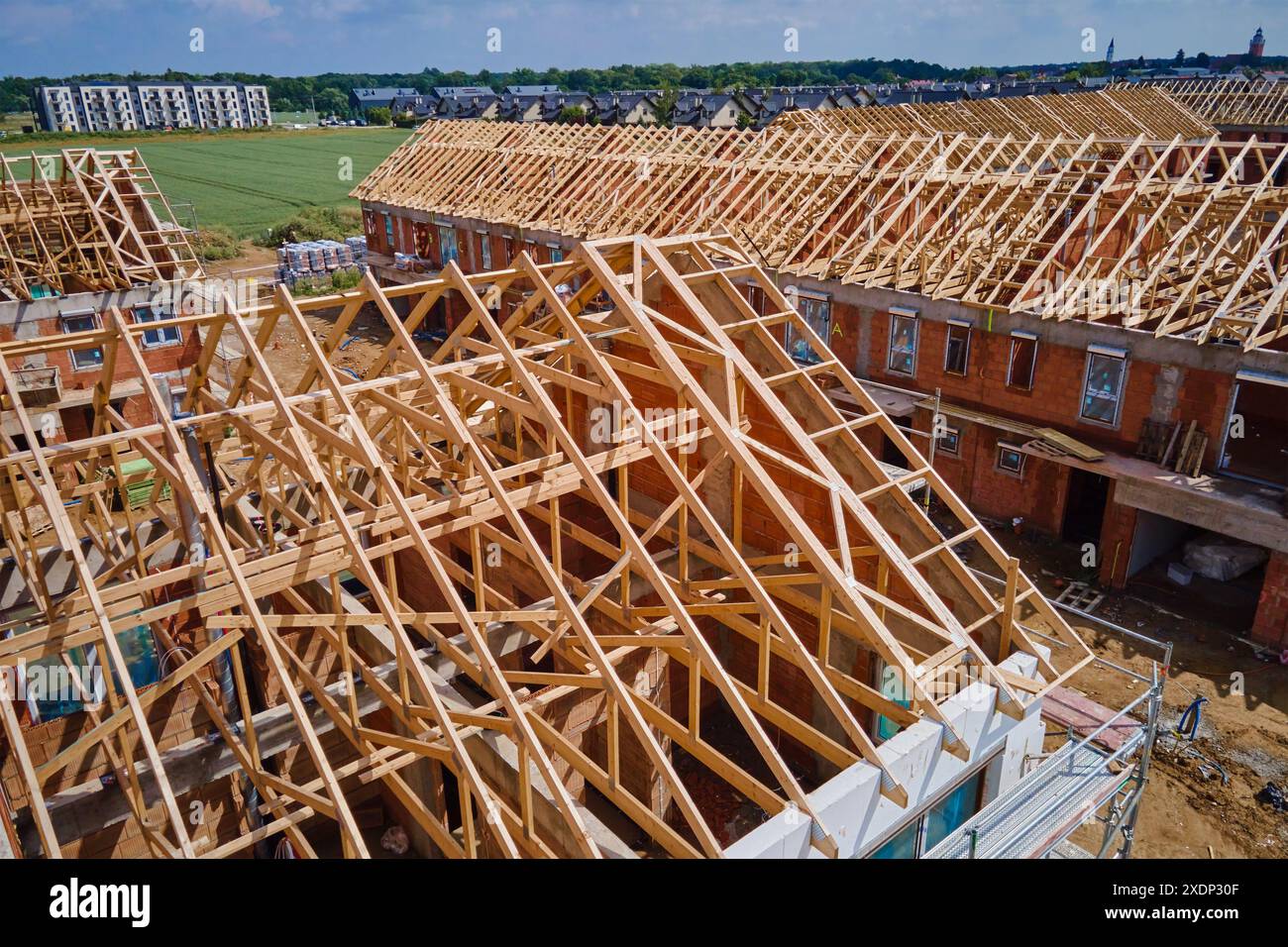 New house under construction, wooden truss system forming roof. Process ...