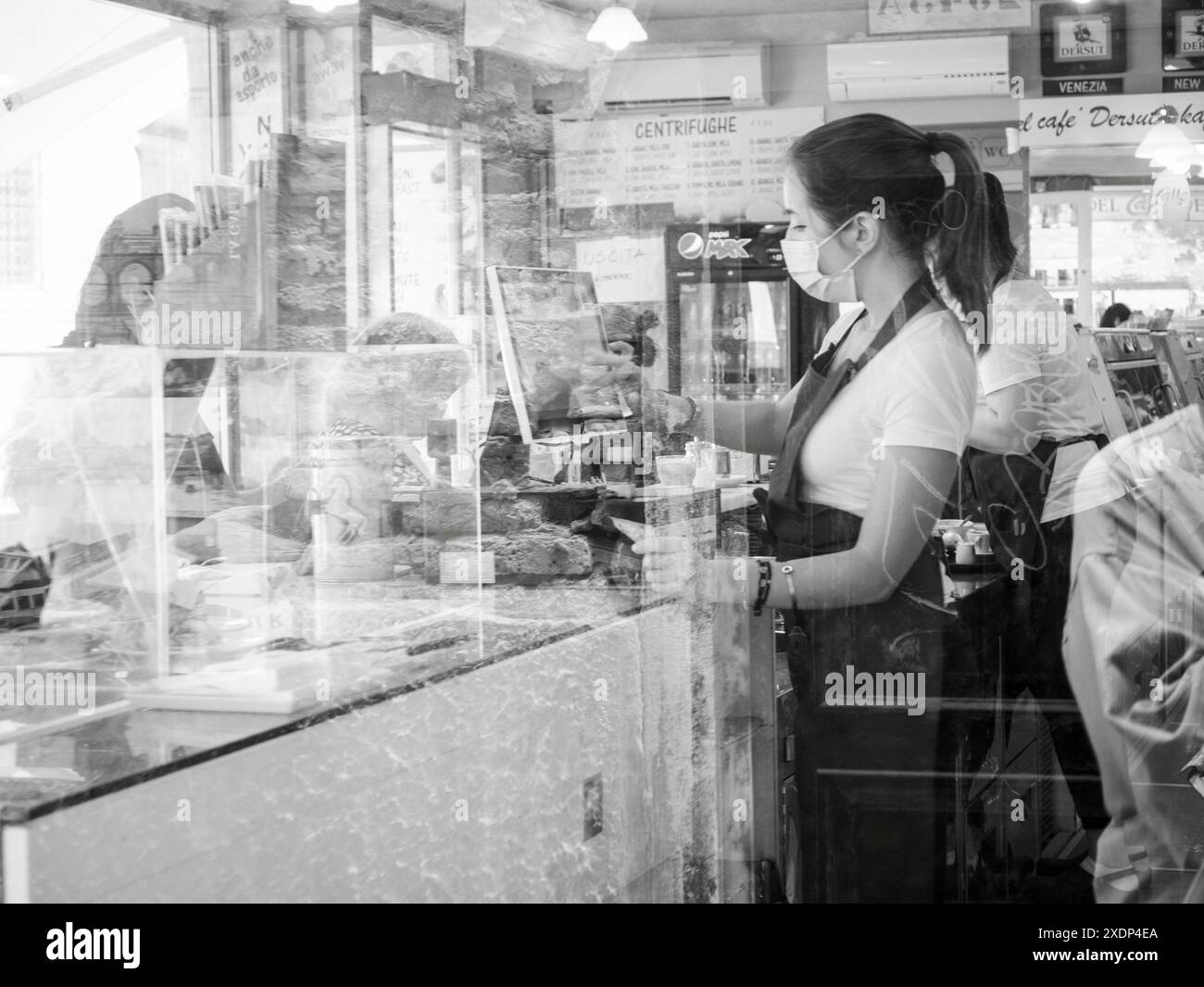 Venice, Italy - June 30th 20220 Black and white photo of a cashier ...